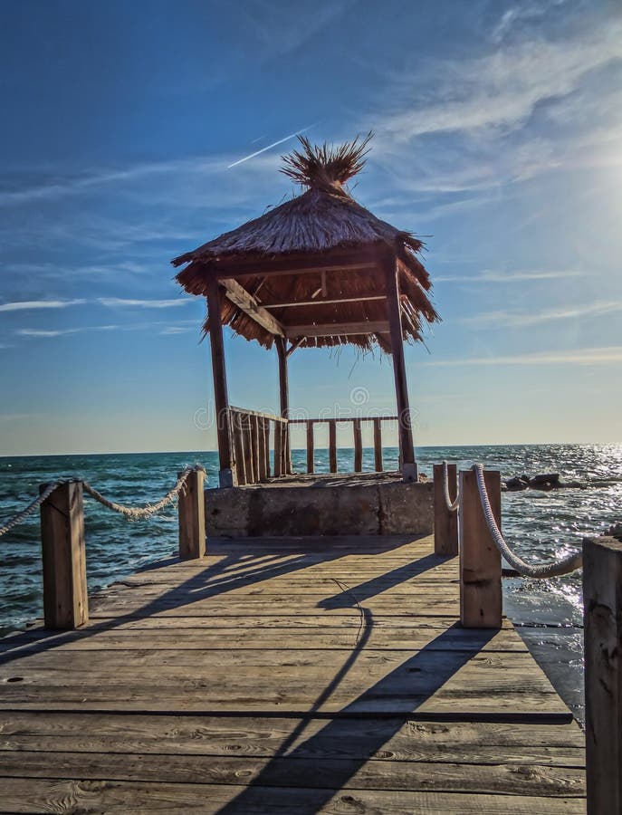 A Beautiful Straw Hut in the Sea Lighted by the Summer Sun. Stock Image ...