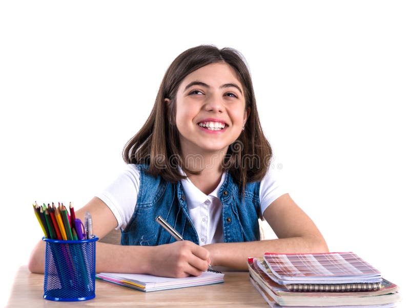 A Beautiful Student Girl Sits at the Desk and Writes the Letter. Stock ... A Beautiful Student Girl Sits at the Desk and Writes the Letter. Stock ...