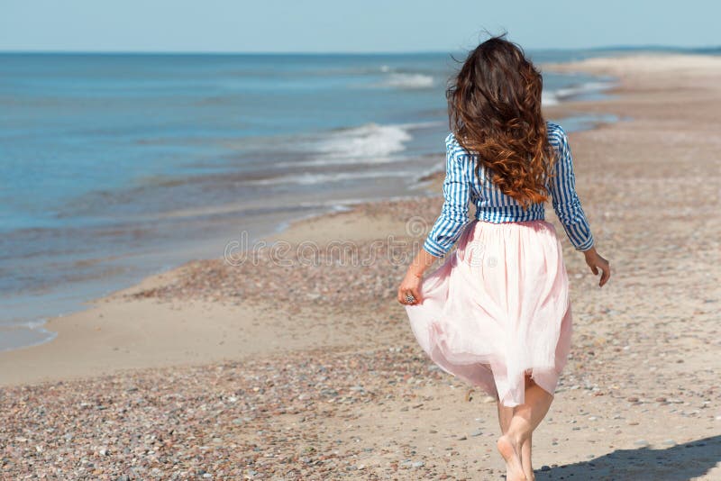 Beautiful and Stylish Brunette Walking on the Beach. Back View Stock ...