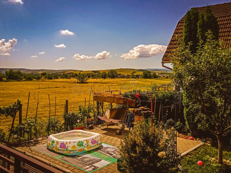 Beautiful Summer Morning with Backyard and the Sky with Small Clouds ...