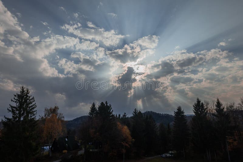 Beautiful Sun Streaks Coming Out from the Heavy Clouds on the Sky Stock ...