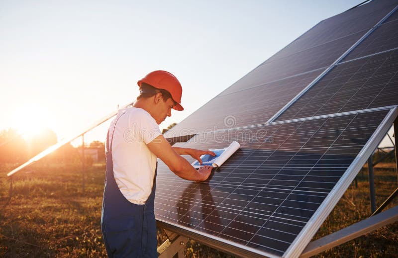 Beautiful Sunlight. Male Worker in Blue Uniform Outdoors with Solar ...