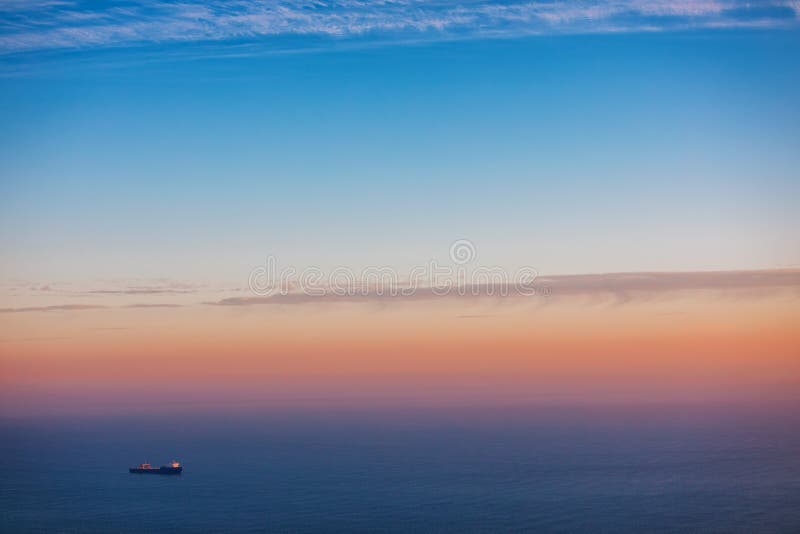 Beautiful Sunrise Over the Sea and Sailing Cargo Ship Stock Photo ...