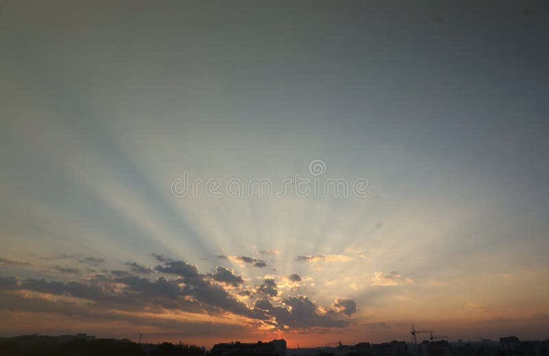 Beautiful Sunrise with Warm Orange Sunlight and Beams through Blue Sky ...