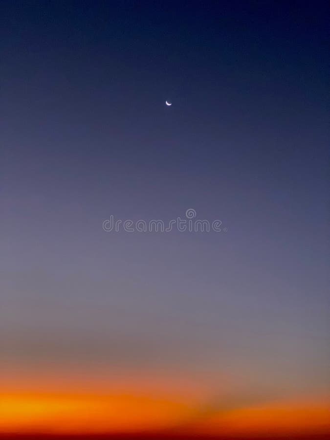 A Beautiful Sunset with the Colorful Sky and the Moon Rising on the ...