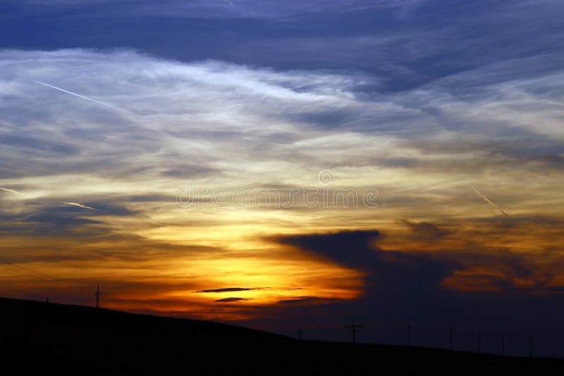 A Beautiful Sunset with Dark Clouds Over a Field Stock Image - Image of ...