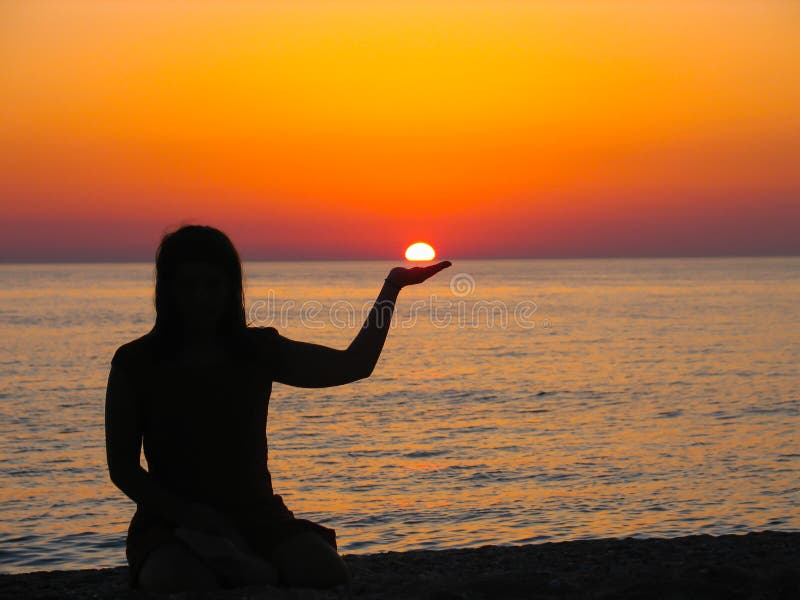 Beautiful Sunset with a Girl S Silhouette Holding the Sun. Stock Photo ...