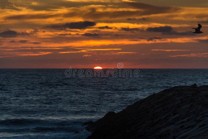 Beautiful Sunset with the Gold Sun Disk and Red Clouds is on the Ocean ...