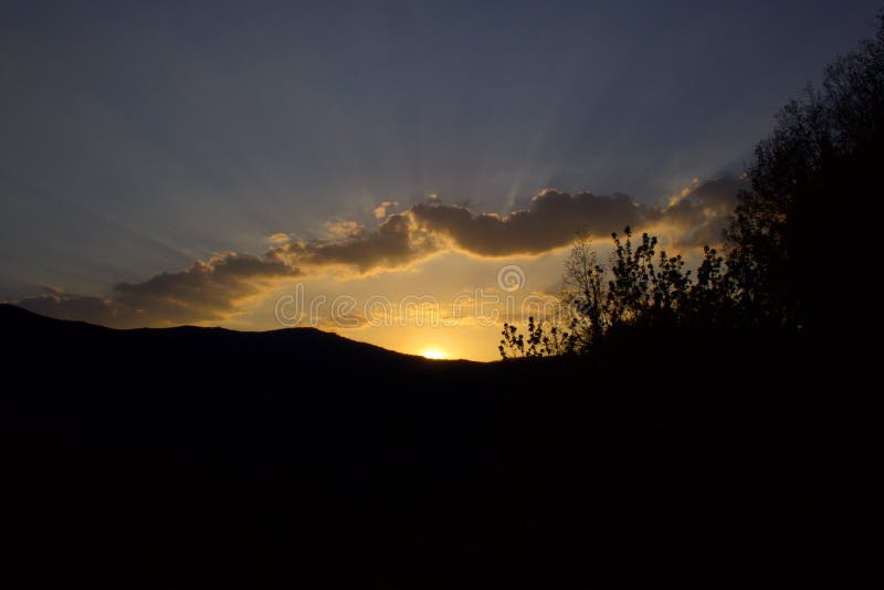 Beautiful Sunset on the Hills with Sun Rays Breaking through Th Stock ...