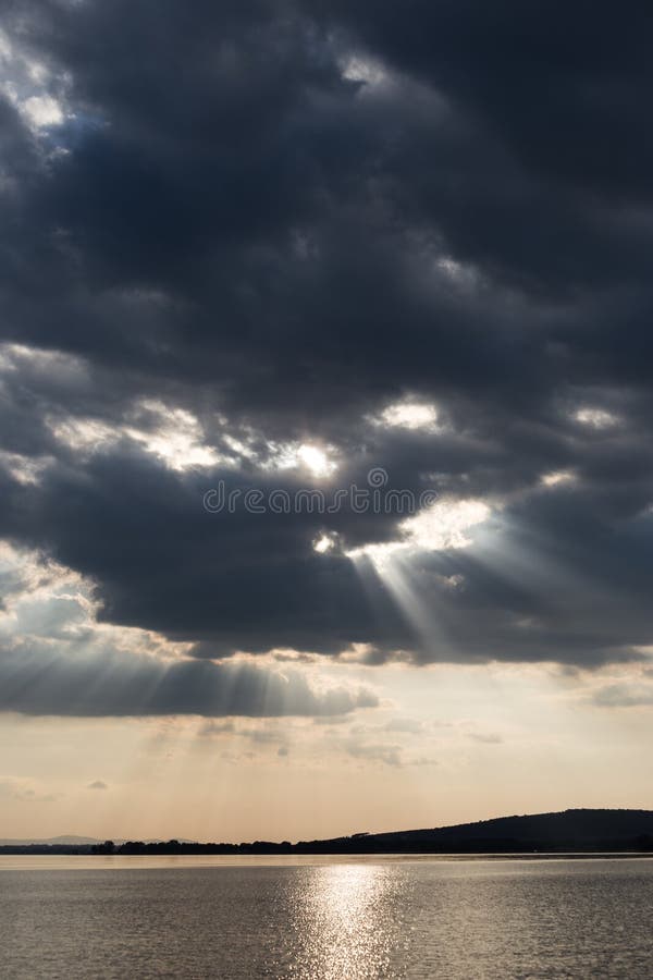 Beautiful Sunset on a Lake, with Sunrays Coming Down Under an Overcast ...