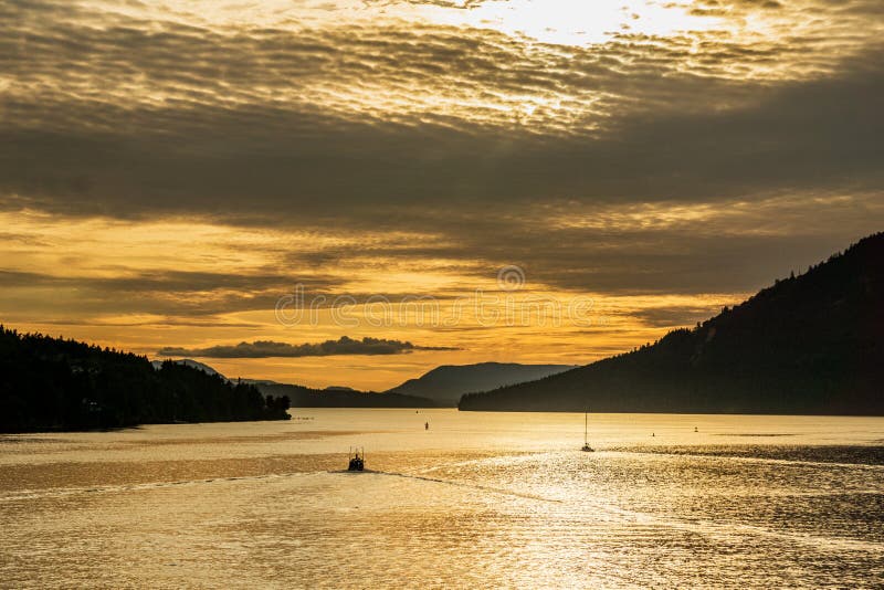 Beautiful Sunset Ocean Bay with Orange Sky Mountains and Clouds Stock ...
