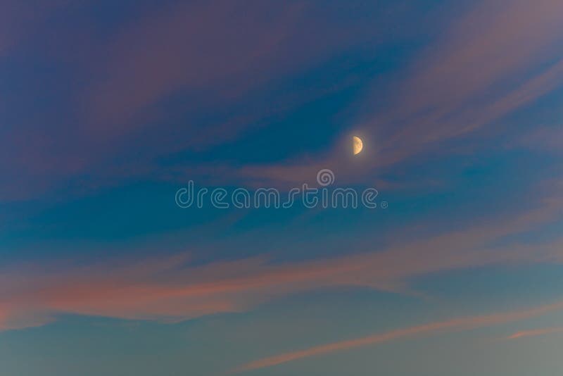 Beautiful Sunset with Orange Clouds, Deep Blue Sky and Moon Stock Photo ...