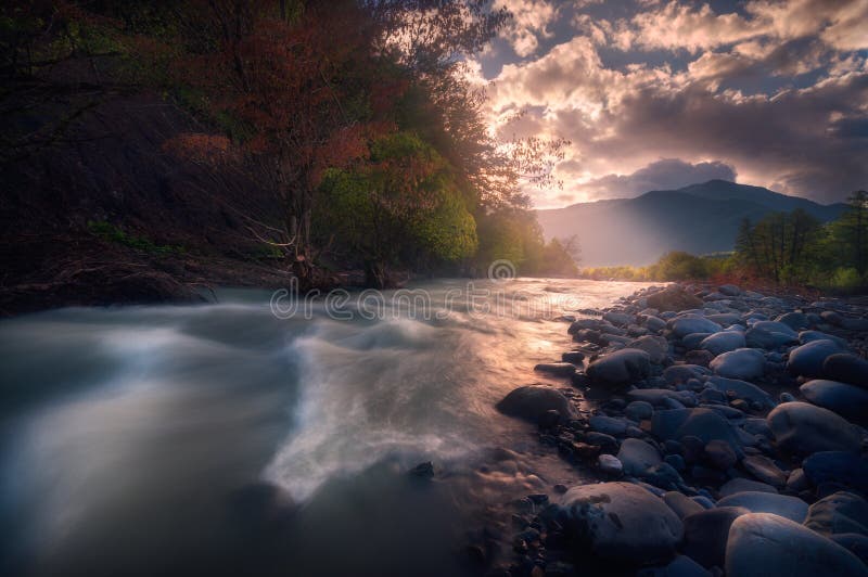 Beautiful Sunset Over Fast Flowing Mountain River. Colorful Summer ... Beautiful Sunset Over Fast Flowing Mountain River. Colorful Summer ...