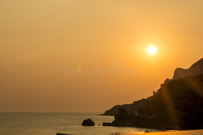 Beautiful Sunset Over the Ocean and Cliffs in Corfu, Greece Soft Orange ...