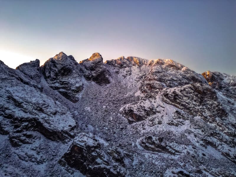 Beautiful Sunset Over a Rocky Snow-covered Hill Stock Photo - Image of ...