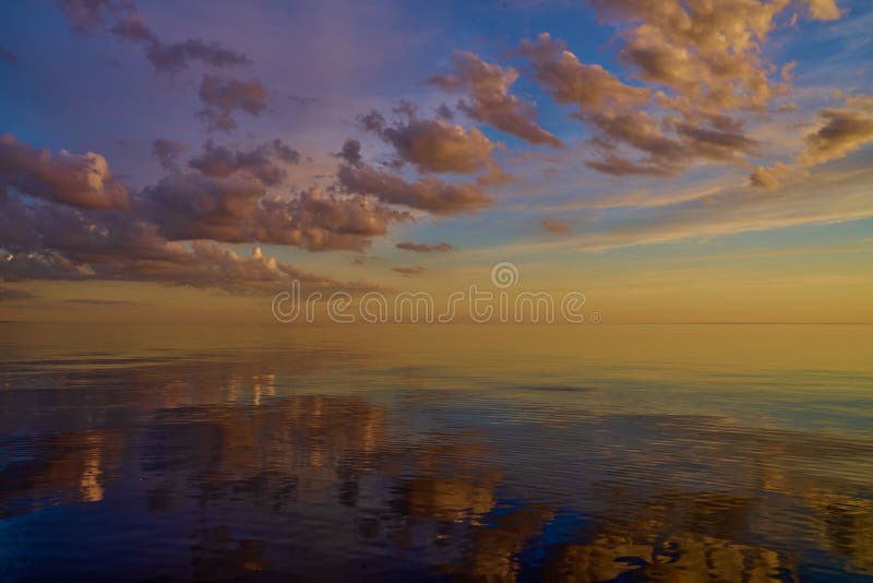 Beautiful Sunset Over Sea with Reflection in Water, Majestic Clouds in ...