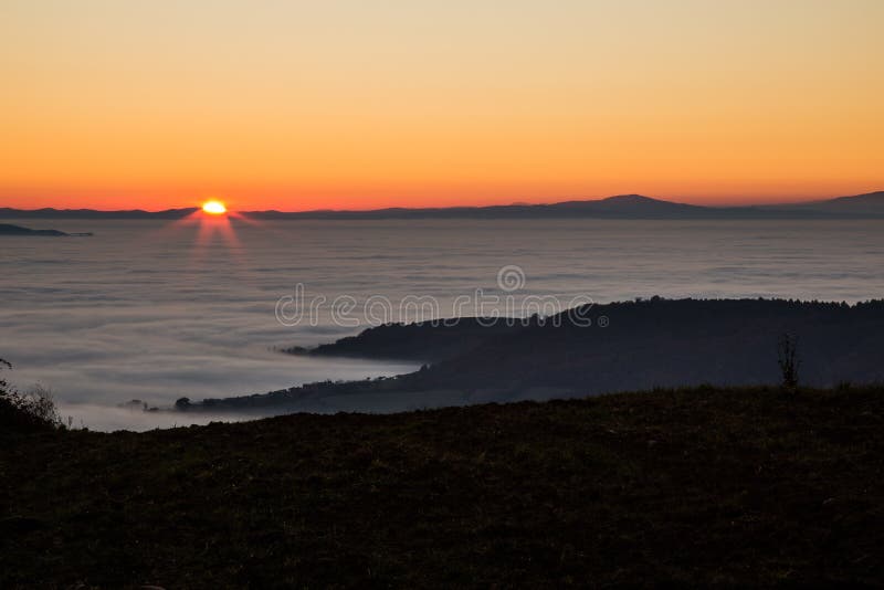 Beautiful Sunset Over a Valley Filled by Fog Stock Image - Image of ...