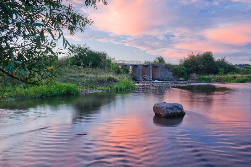 Beautiful Sunset on the River. Old Bridge Over the River in the ...