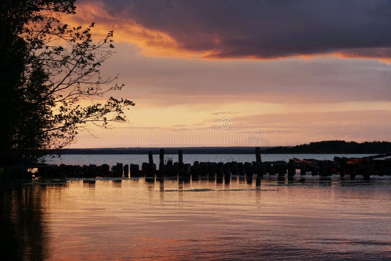 Beautiful Sunset on the River. Pink Sky and Dark Pillars from the ...