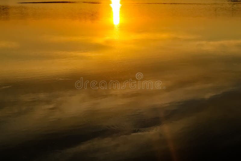 Beautiful Sunset. the Setting Golden Sun is Reflected in the Water ...