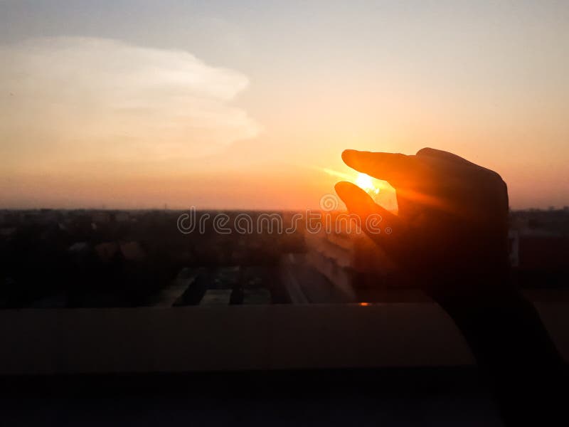 Silhouette touch the sun stock photo. Image of light - 156682844