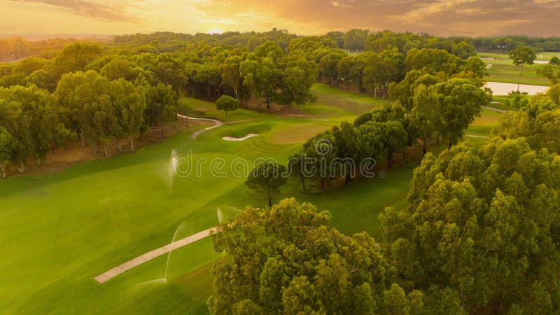Beautiful Sunset Sky Over a Golf Course during Evening Grass Watering ...