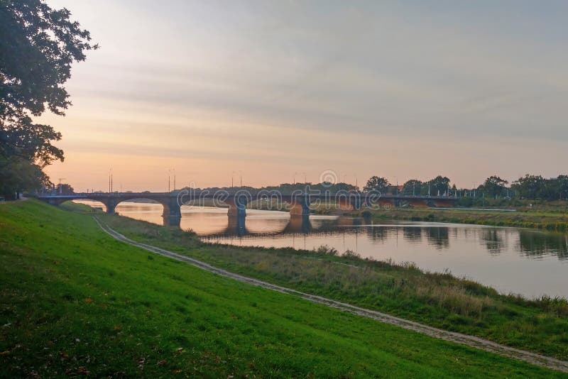 Beautiful Sunset View on the River Bank. View of the Bridge. Stock ...