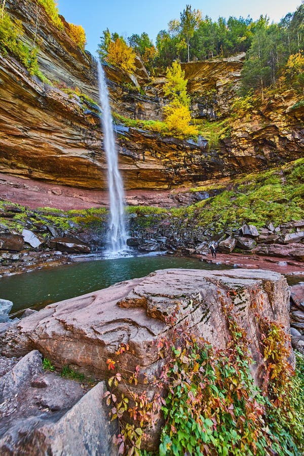 Beautiful Tall Waterfall Over Layered Cliffs Down To Waters and Large ...