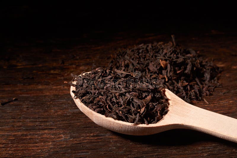 Beautiful Tea in a Wooden Spoon on a Black Background. Stock Photo ...