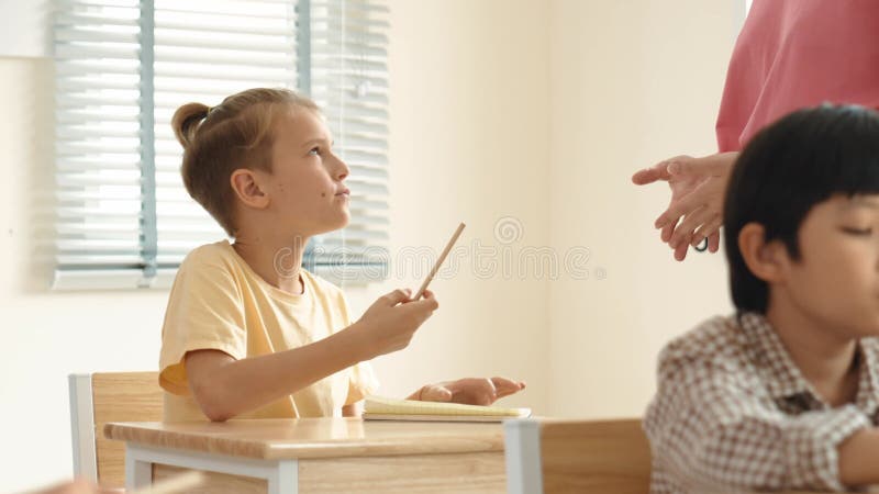 Beautiful Teacher Explaining Test while Caucasian Boy Doing Classwork ...