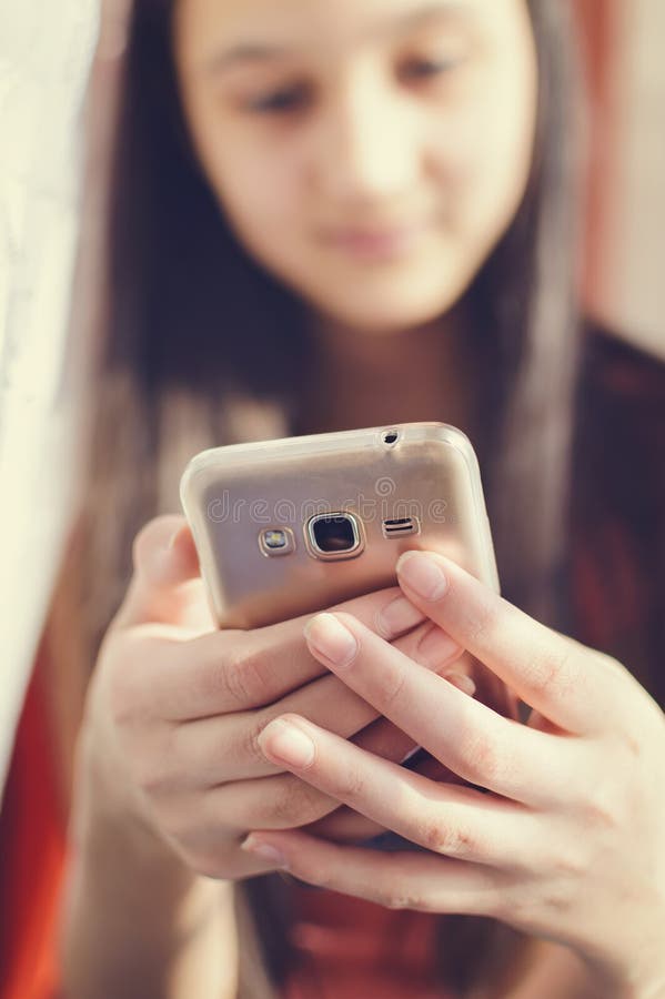 Beautiful Teen Girl Holding a Mobile Phone. Lifestyle Style Stock Image ... Beautiful Teen Girl Holding a Mobile Phone. Lifestyle Style Stock Image ...