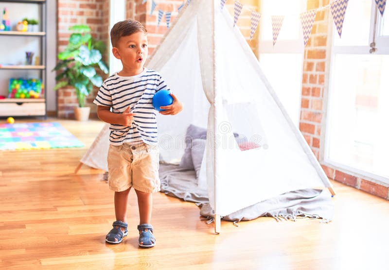 Beautiful Toddler Boy Playing with Colored Small Balls at Kindergarten ...