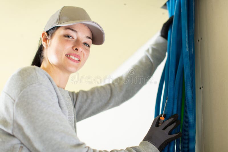 Beautiful Tradeswoman Installing Electrical Wiring Stock Photo - Image ...