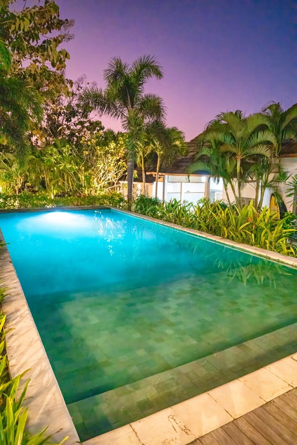 A Beautiful Tropical Resort with Pool at Night with Palms Stock Photo ...