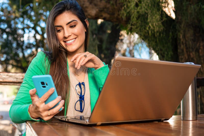Student Checking Messages on Smart Phone in Table Outside Stock Image ...