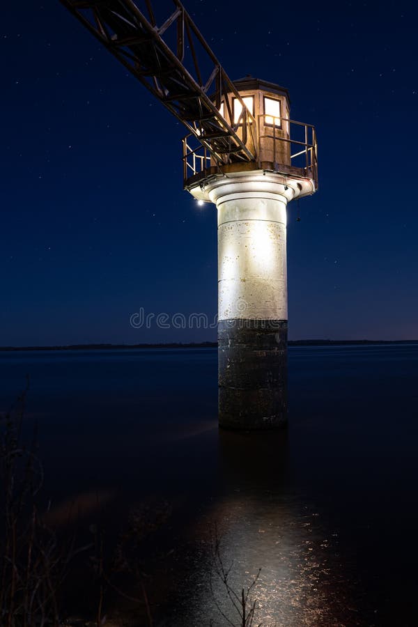 Beautiful Vertical Picture of a Lighthouse at Night Under the Starry ...