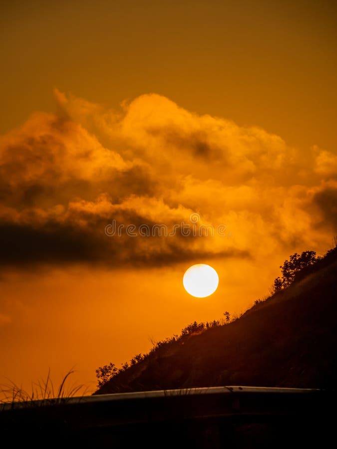 Beautiful Vertical Shot of a Shining Round Sun in an Orange Sky with ...