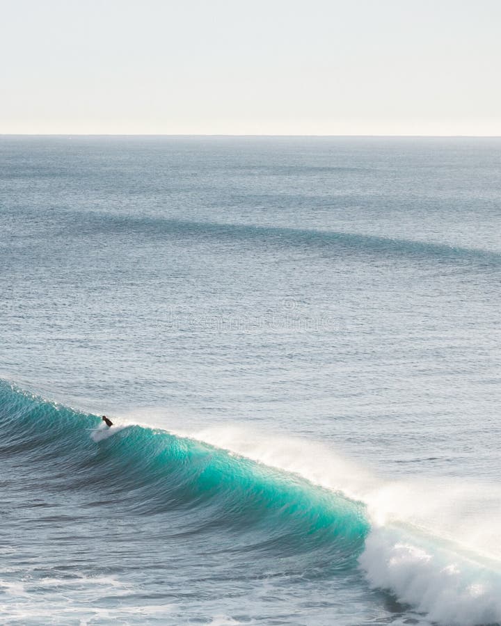 Beautiful Vertical Shot of a Surfer Catching a Wave Stock Image - Image ...