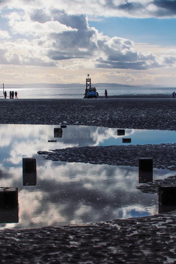 Beautiful Vertical View of a Lighthouse from a Beach with Reflective ...