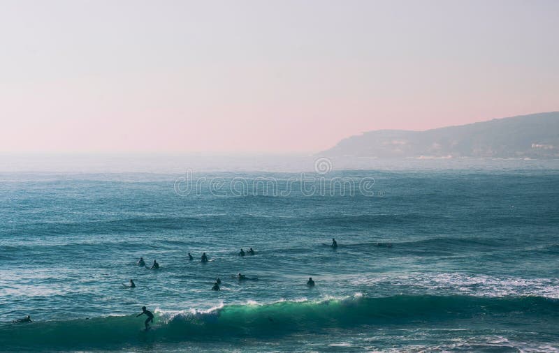 Beautiful View of a Blue Seascape with Surfers Catching Waves in ...