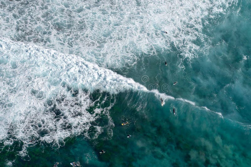 Beautiful View of a Blue Seascape with Surfers Catching Waves in ...