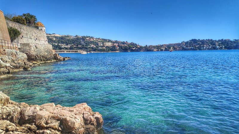 Beautiful View of a Bright, Shallow Sea with Cliffs Looming Over it ...