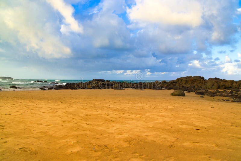 Golden Sand Beach with Clouds Stock Image - Image of lovely, rocks ...