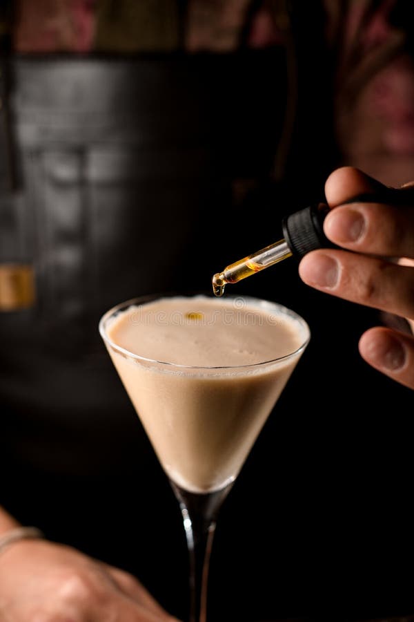 Beautiful View on Drop of Falling Out of Dropper in Martini Glass with ...