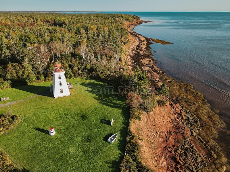 Beautiful View of a Forest on a Cliff with a Lighthouse Under the Blue ...