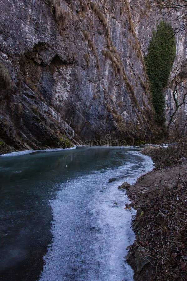 Beautiful View of the Frozen River Surrounded by Rocky Mountains in the ...