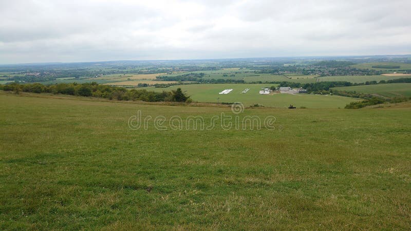 Beautiful View of Green Fields with Trees Under the Cloudy Sky Stock ...