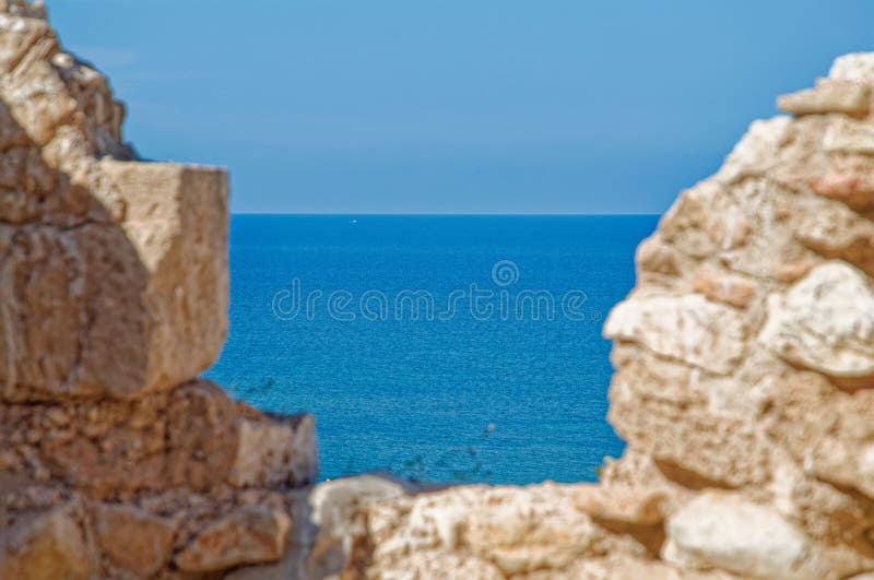 Beautiful View of the Ocean through a Hole in a Stone Wall Stock Image ...