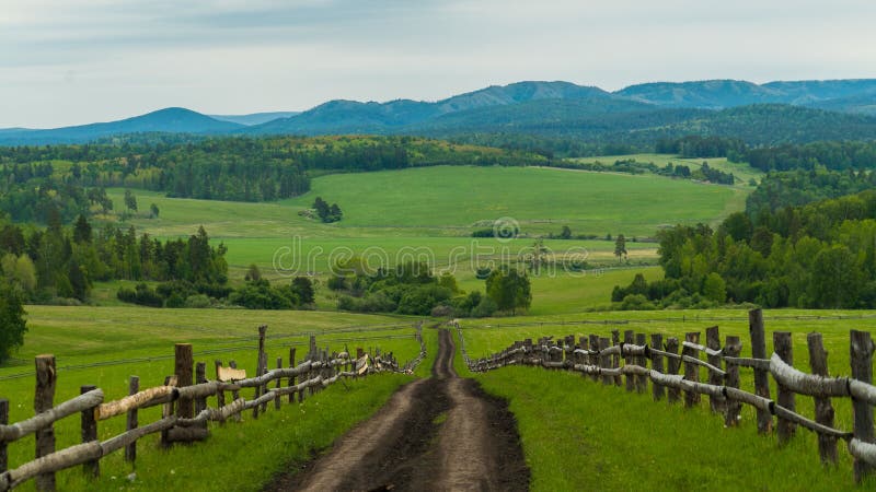 Beautiful View of the Road Leading To a Hilly Valley and Forest Stock ...