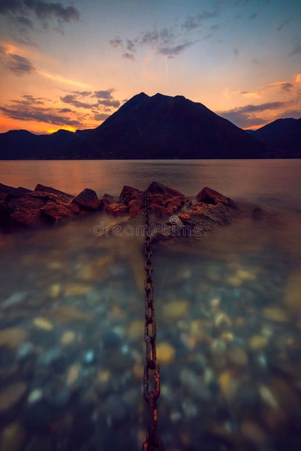 Beautiful View of Rusty Chain and Stones on a Shore with Mountain in a ...